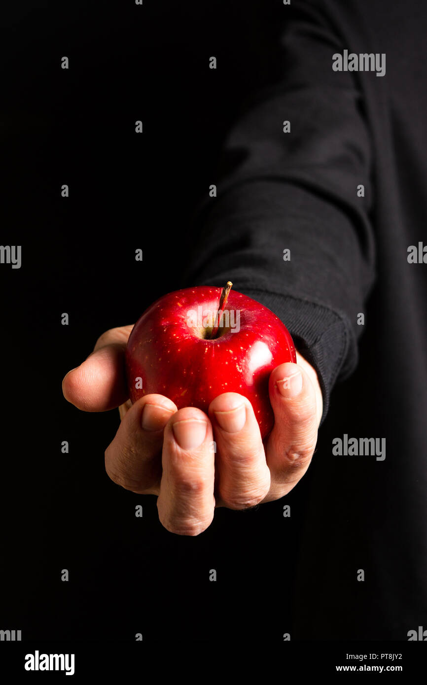 Hand holding red apple dark hi-res stock photography and images - Alamy