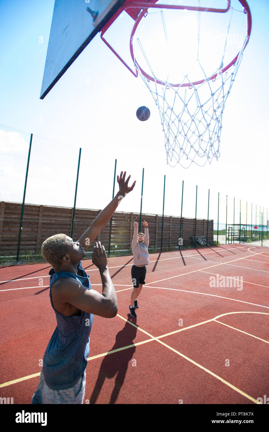 Two young men playing basketball outdoor court hi-res stock photography ...