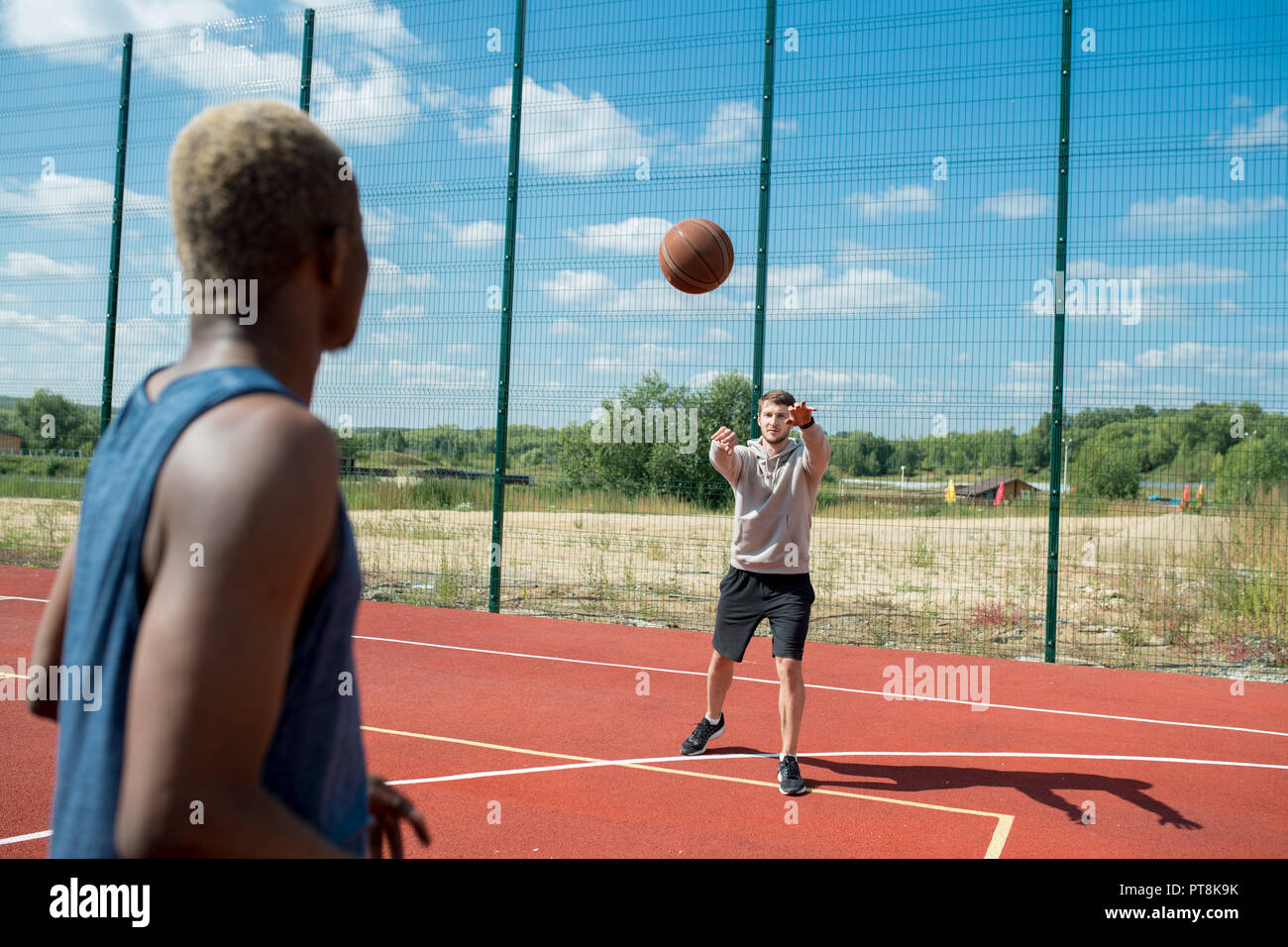 Two young men playing basketball outdoor court hi-res stock photography ...