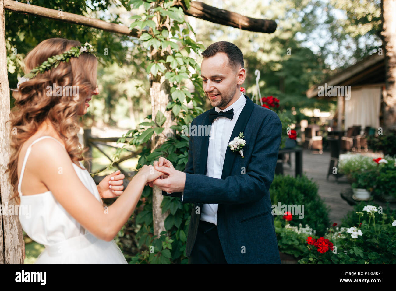 Beauty bride and handsome groom are wearing rings each other. Wedding ...