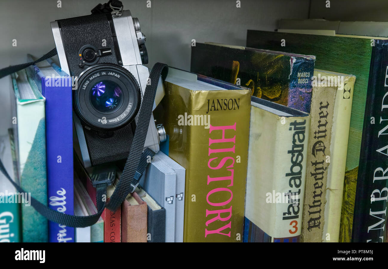 In the library there are classic art books and a vintage film camera ...