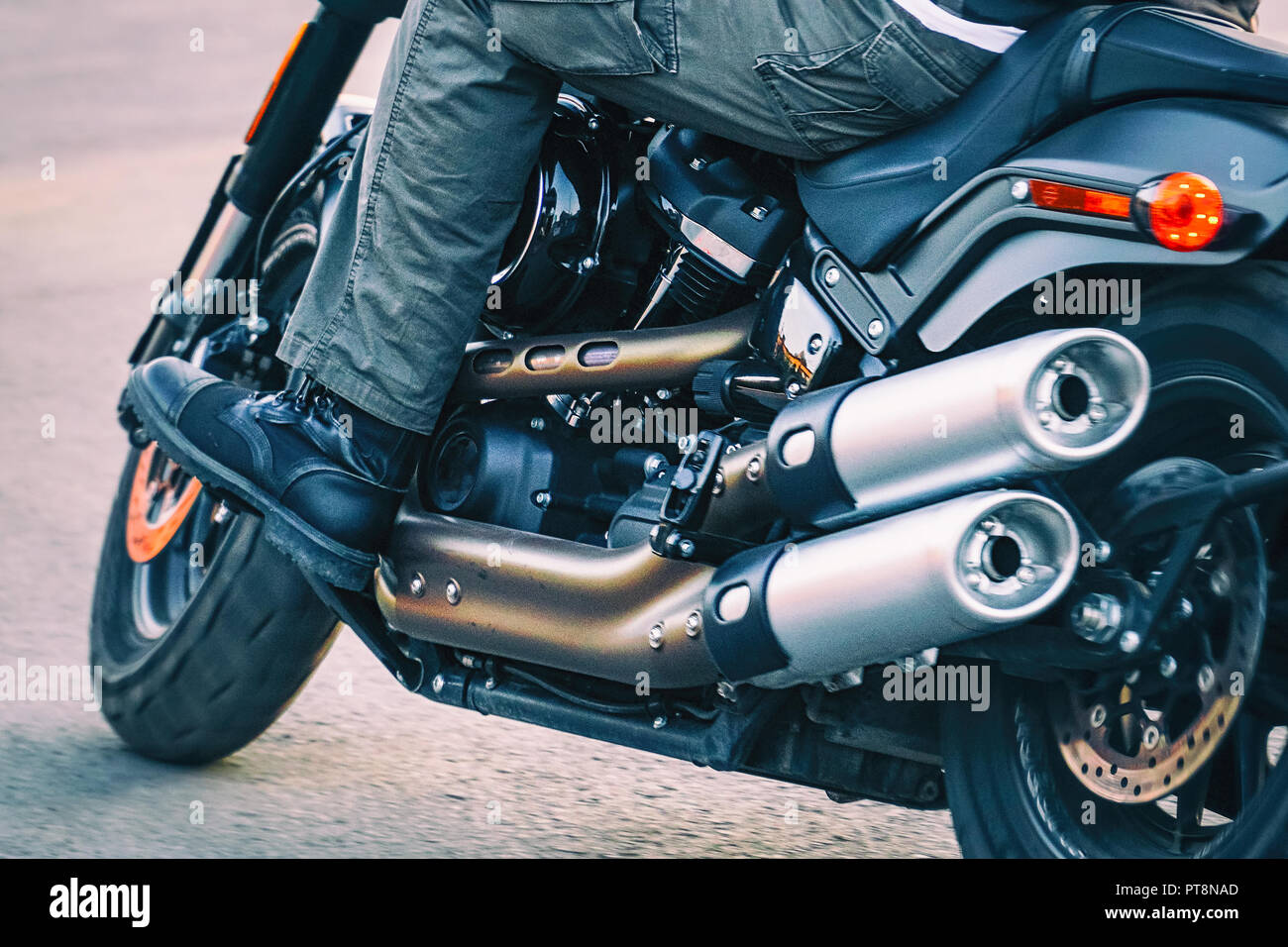 The biker rides a motorcycle. Rear view Stock Photo - Alamy