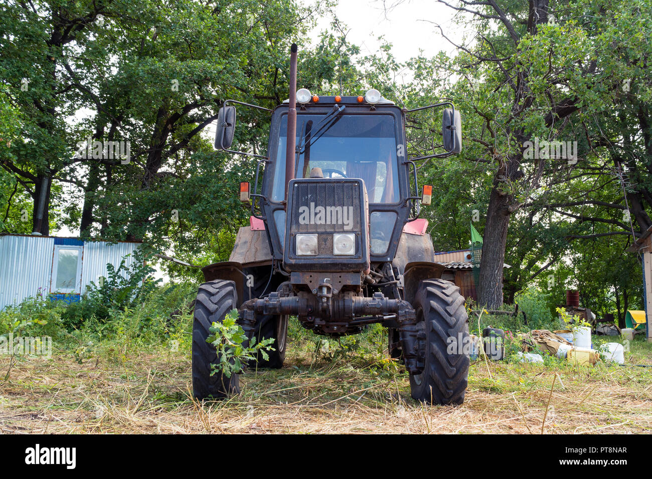 Tractor for working in the field and mowing grass Stock Photo - Alamy