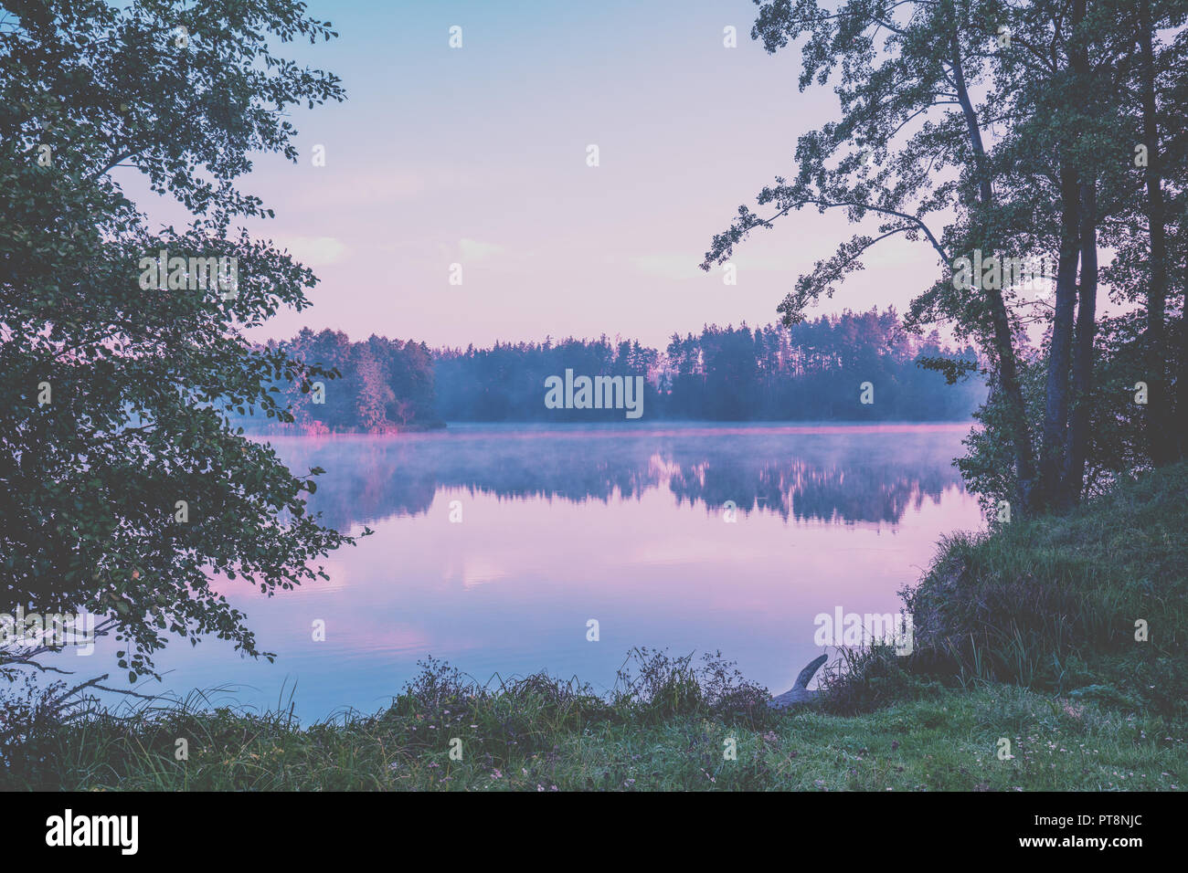 Early morning, sunrise over the lake. Rural landscape Stock Photo - Alamy