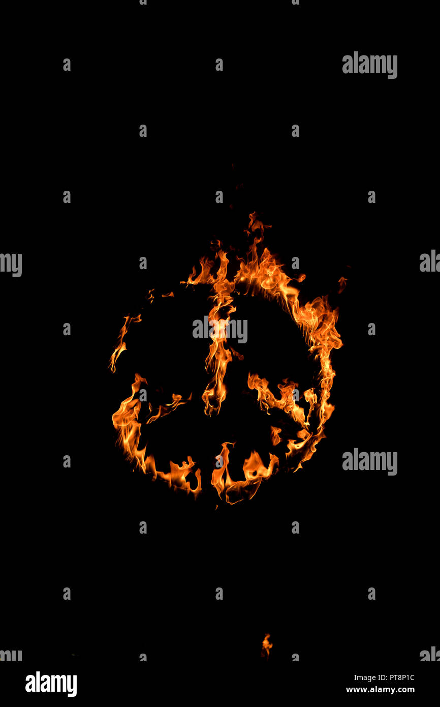 Burning peace symbol over black background Stock Photo - Alamy