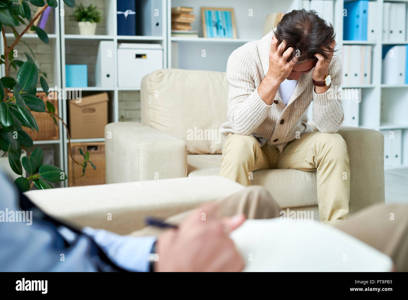 Depressed crying man holding head hi-res stock photography and images ...