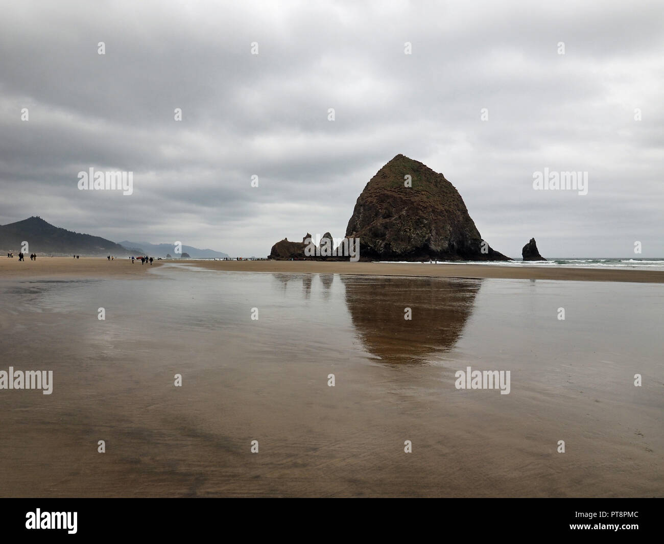 People enjoying the tidepools around Haystack Rock on Cannon Beach ...