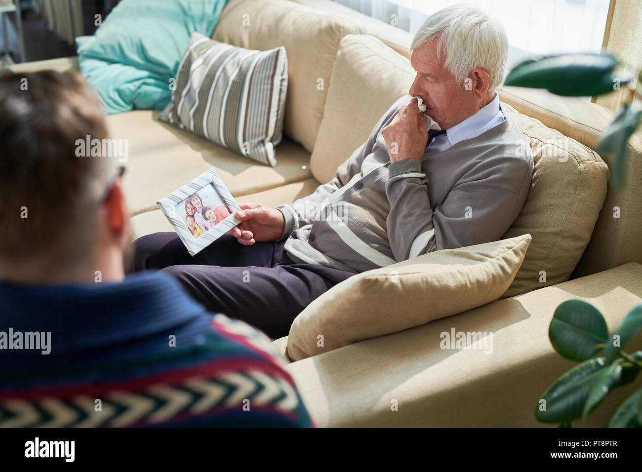 Despaired man sharing his family problems with psychiatrist Stock Photo ...