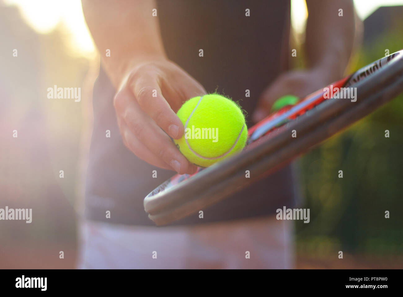 A tennis player prepares to serve a tennis ball during a match with ...