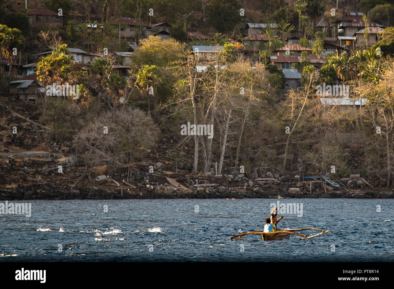 Fishermen in Jukung (indonesian wooden outrigger canoe), Sunda Islands ...