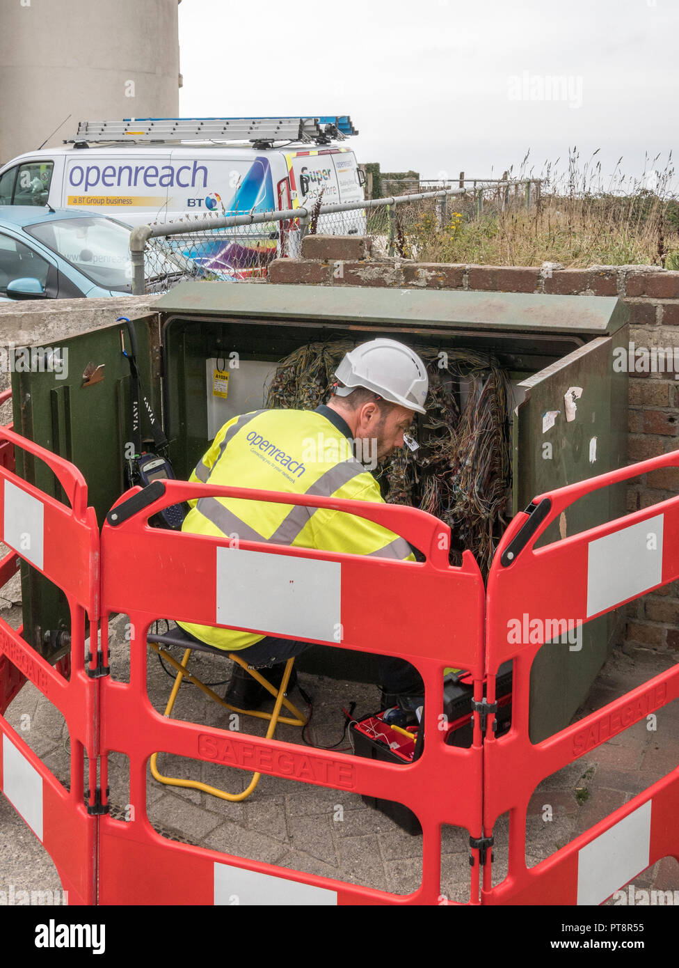 BT Openreach engineer at work at a streetside connection box Stock ...