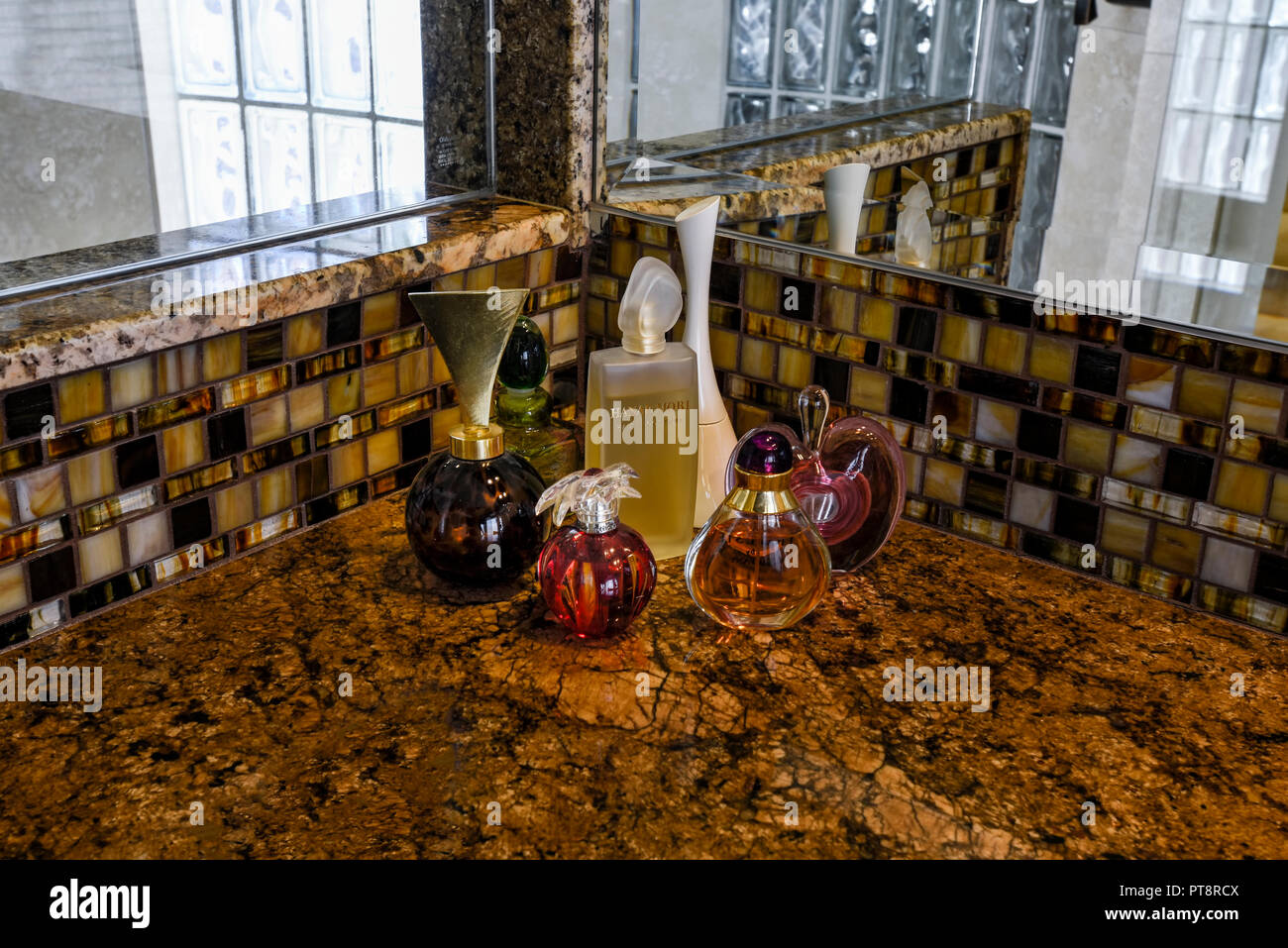 Elegant perfume bottles on a granite counter top Stock Photo - Alamy