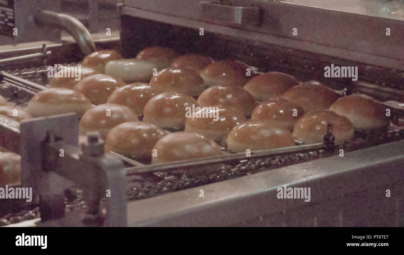Industrial production of donuts by machine Stock Photo - Alamy
