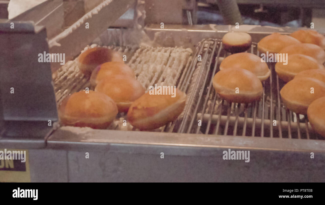 Industrial production of donuts by machine Stock Photo - Alamy