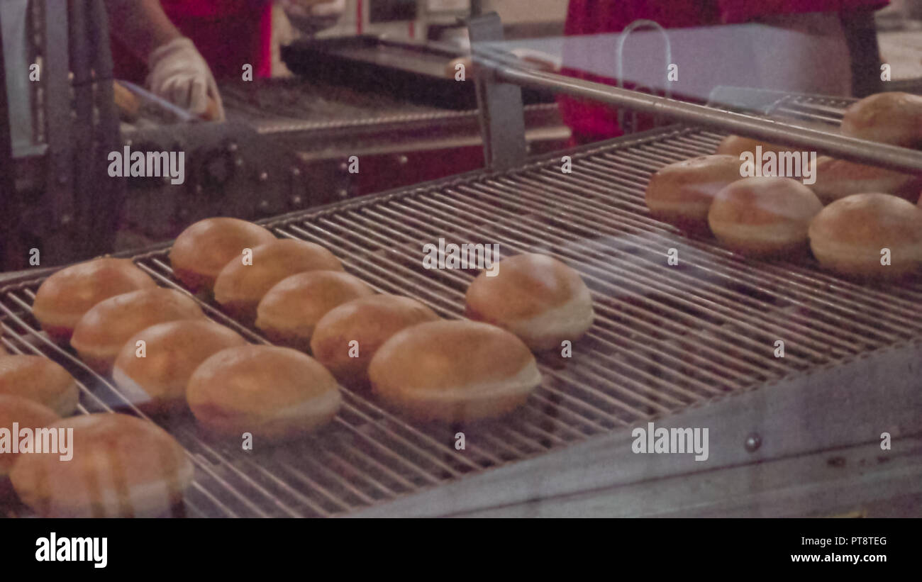 Industrial production of donuts by machine Stock Photo - Alamy
