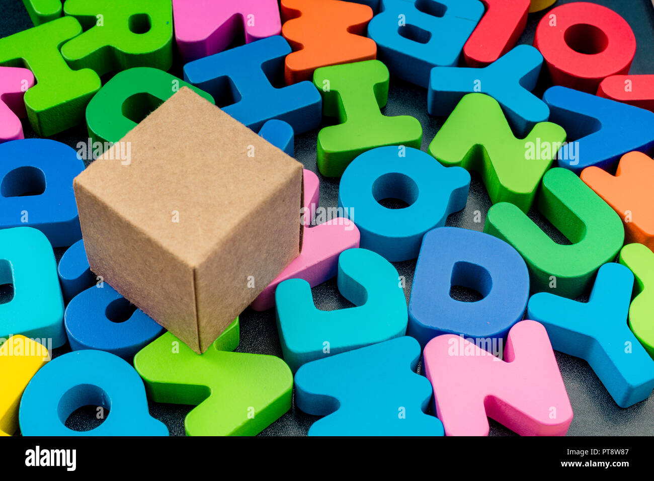 Cardboard box cube and Colorful Letters of Alphabet Stock Photo - Alamy