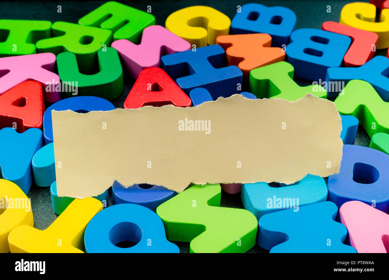 Torn paper placed on Colorful Letters of Alphabet Stock Photo - Alamy