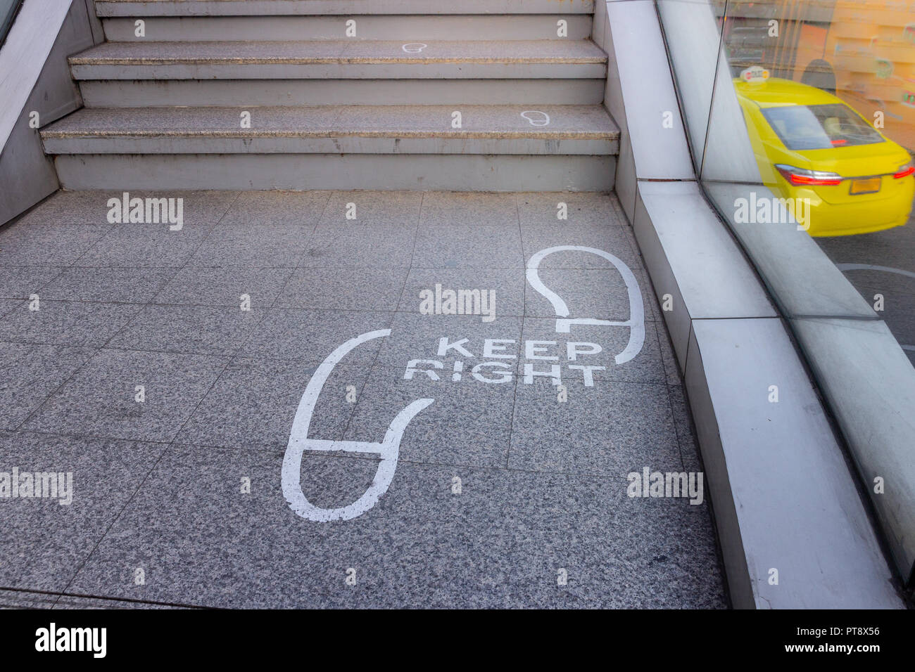 old walkway sign to keep right on floor of flyover Stock Photo - Alamy