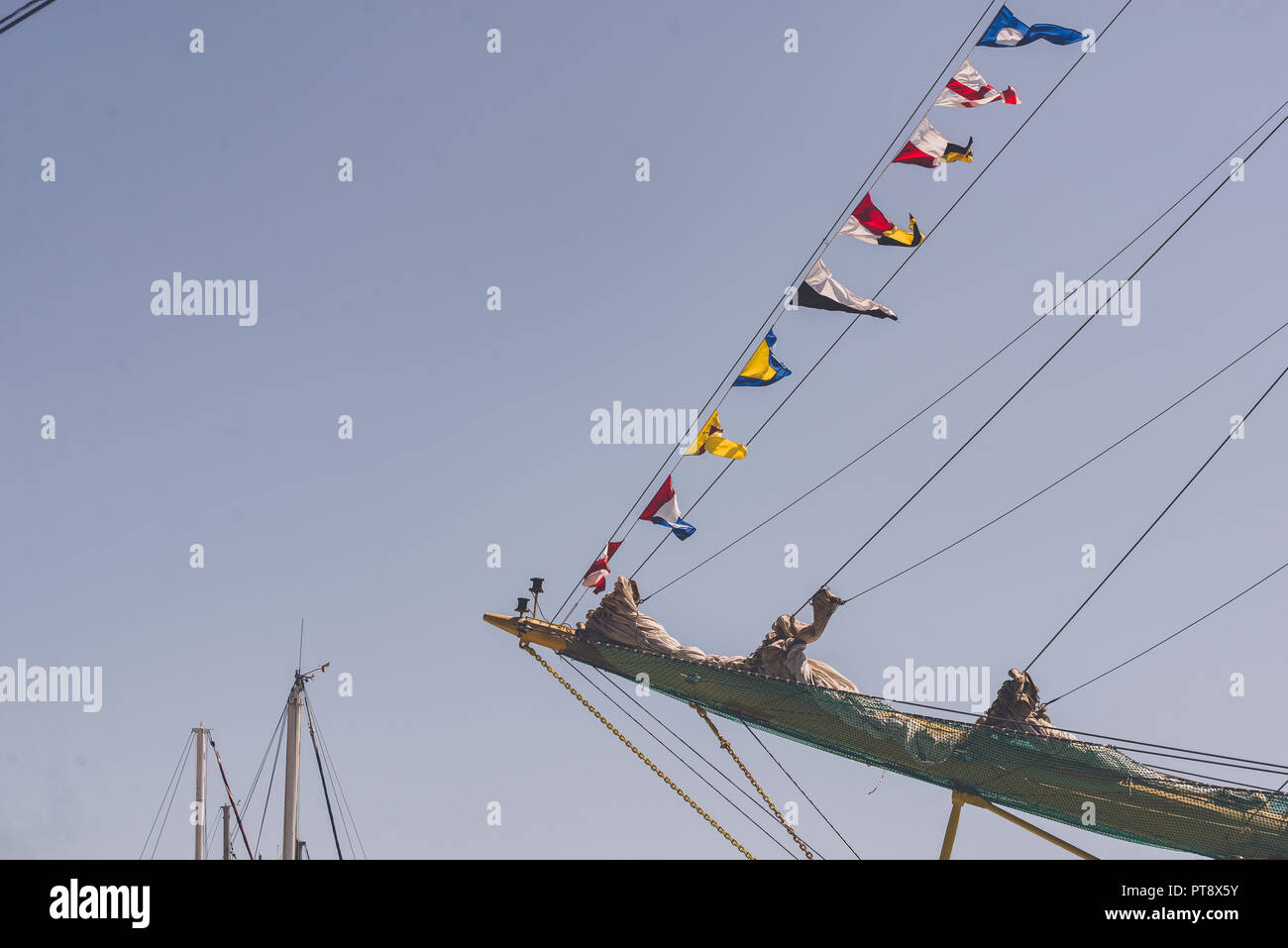 Colorful nautical sailing flags flying in the wind from the lines of a ...