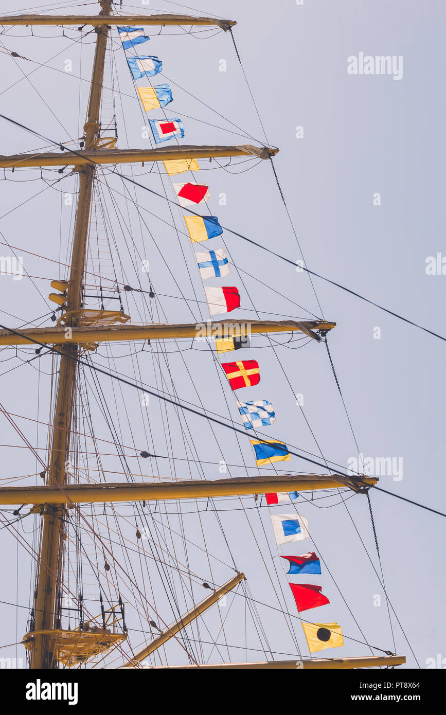 Colorful nautical sailing flags flying in the wind from the lines of a ...