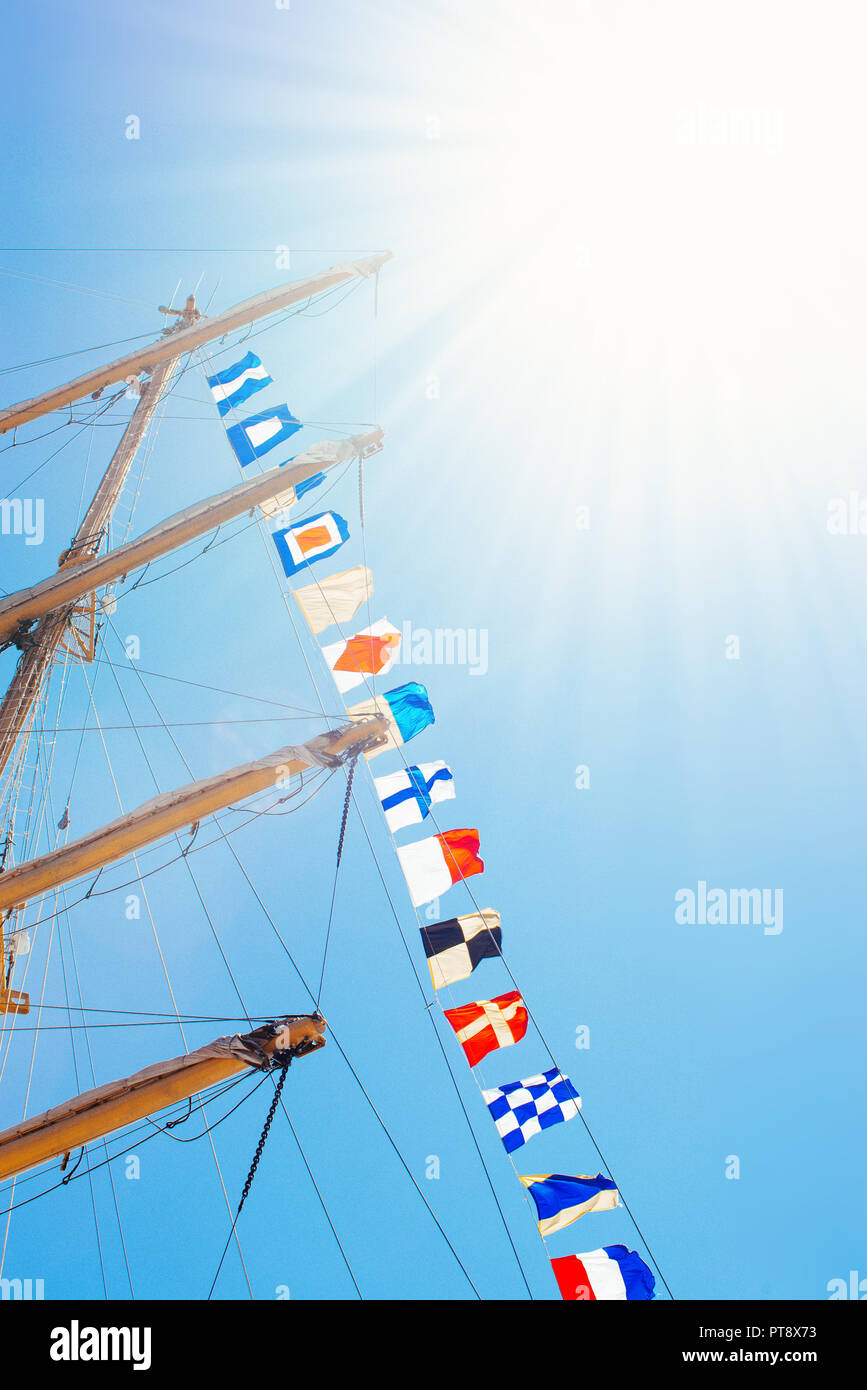 Colorful nautical sailing flags flying in the wind from the lines of a ...