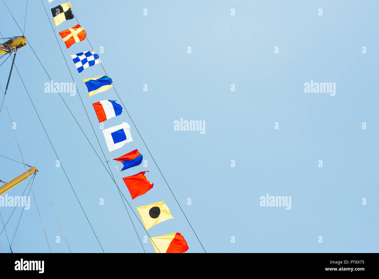 Colorful nautical sailing flags flying in the wind from the lines of a ...