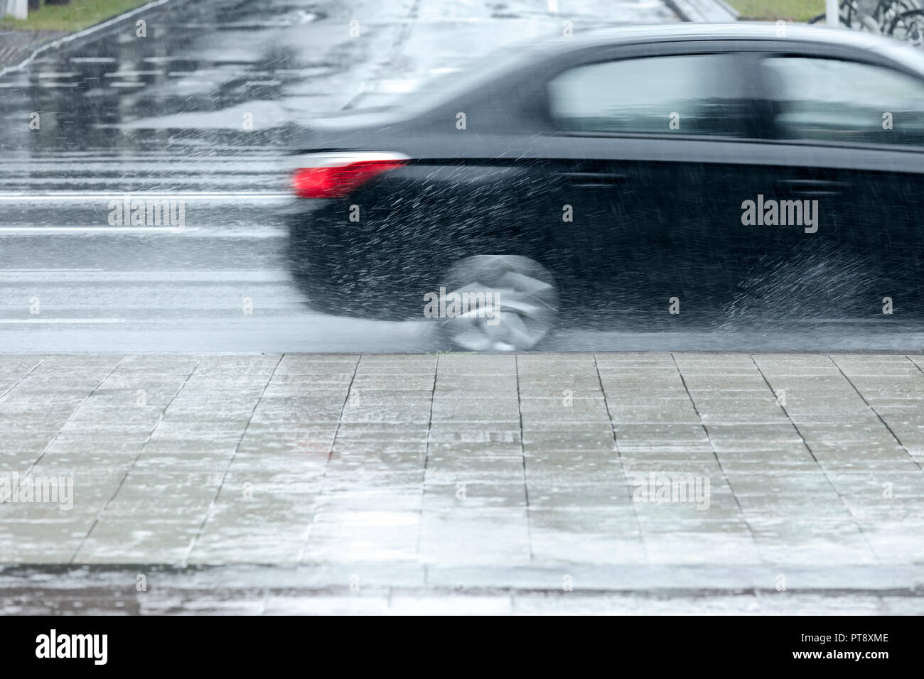 water splashing from car wheels of a car moving in high speed on ...