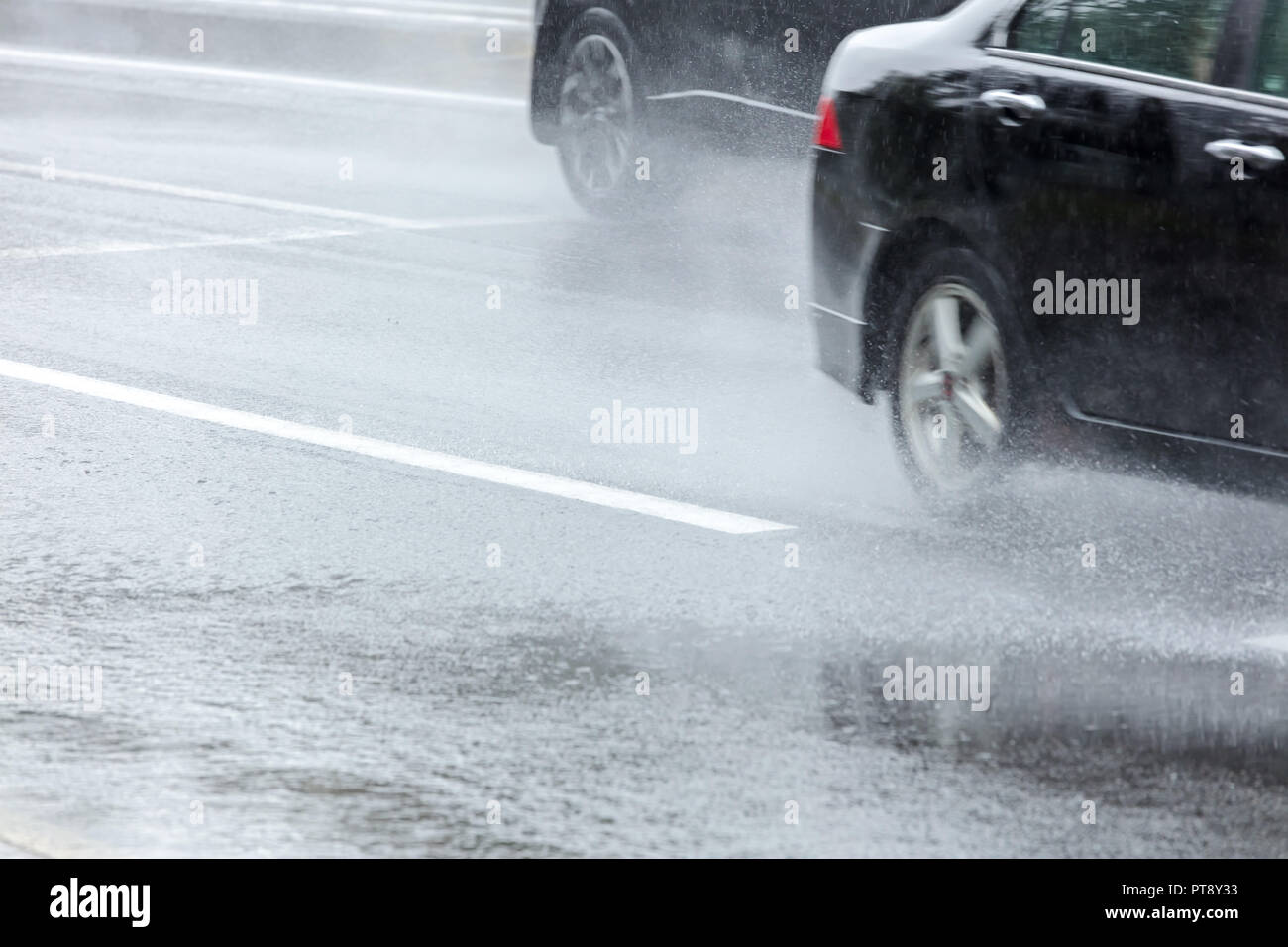 cars driving on flooded city road during heavy rain Stock Photo - Alamy