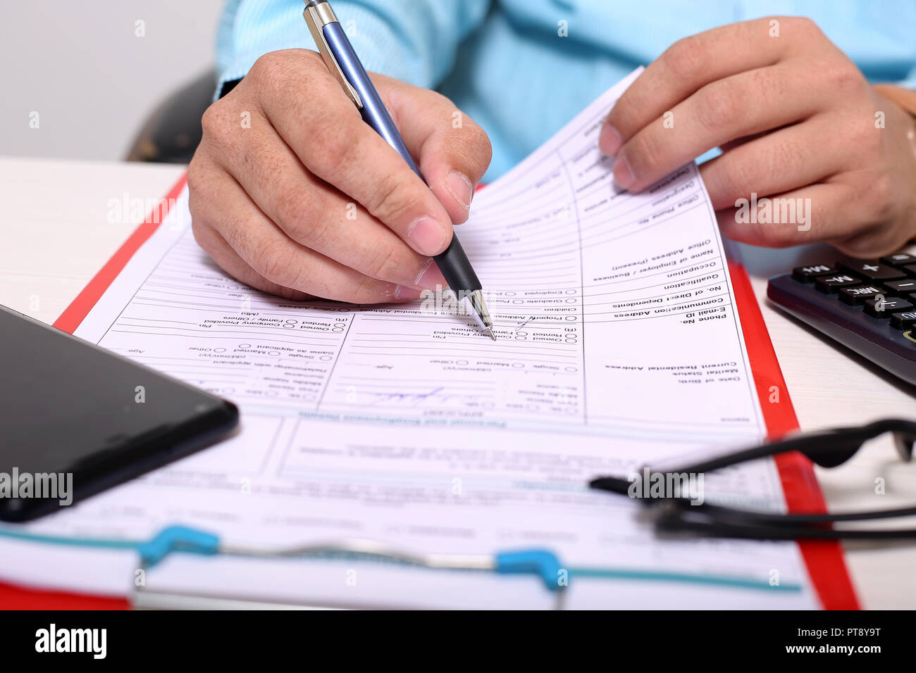 Man is filling form with pen. Picture of form on the clipboard Stock ...