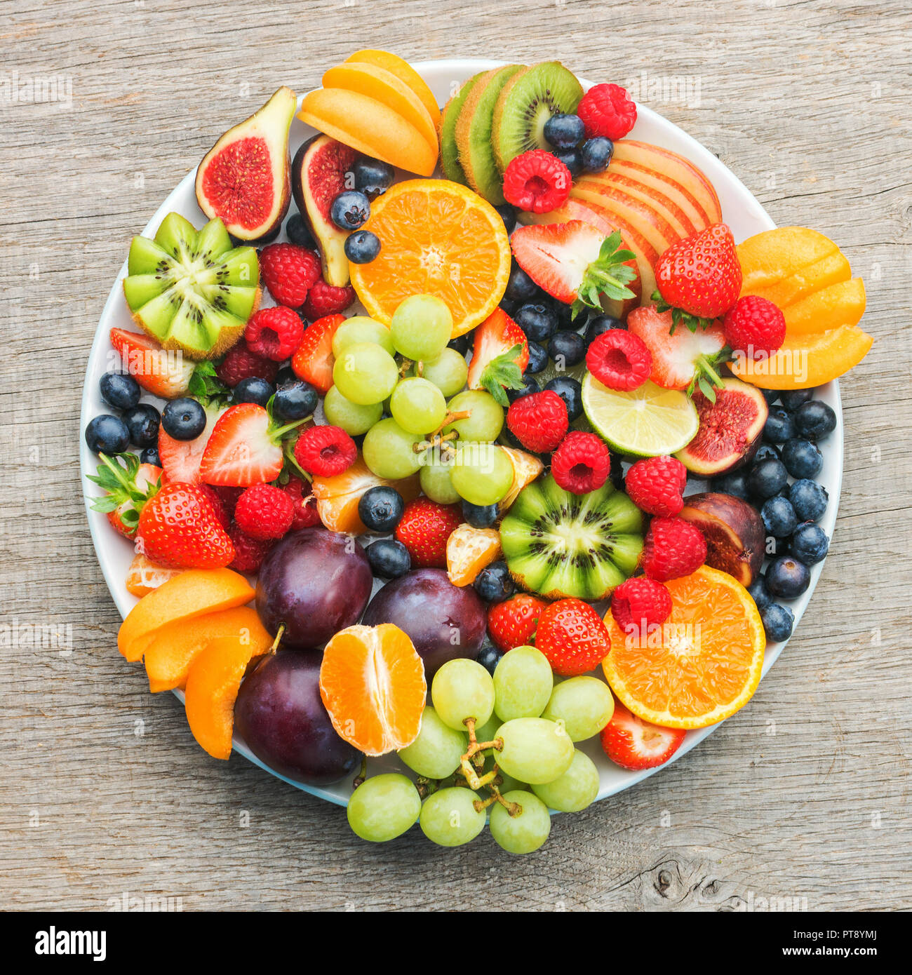 Healthy fruit platter, strawberries raspberries oranges plums apples ...