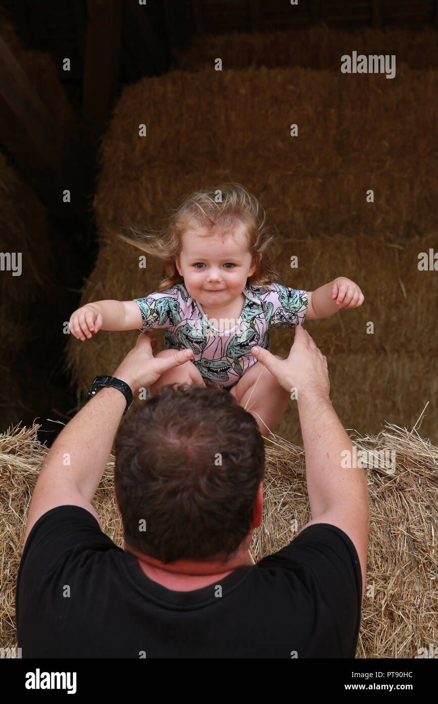 Child jumping fathers arms hi-res stock photography and images - Alamy