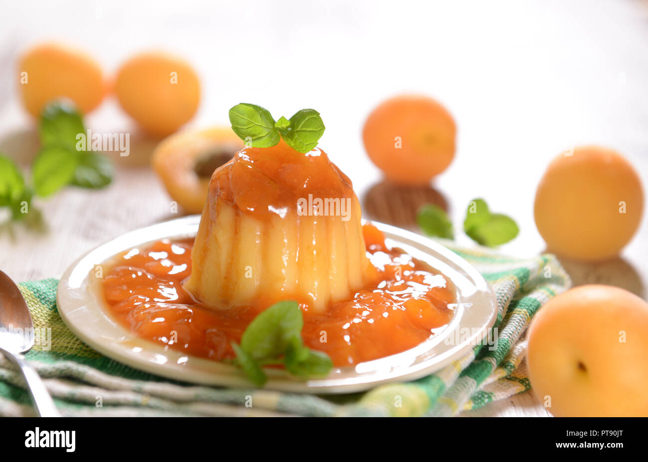 Panna cotta with apricots/peach suace Stock Photo - Alamy