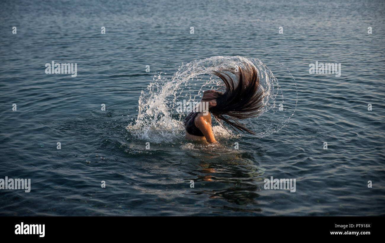Woman flipping hair water hi-res stock photography and images - Alamy