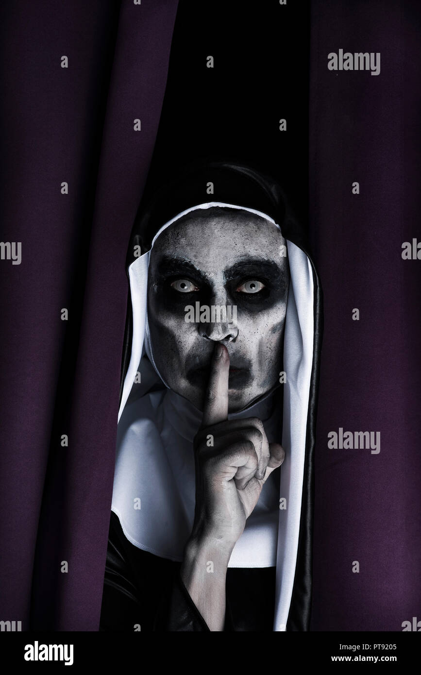 closeup of a frightening evil nun, wearing a typical black and white ...
