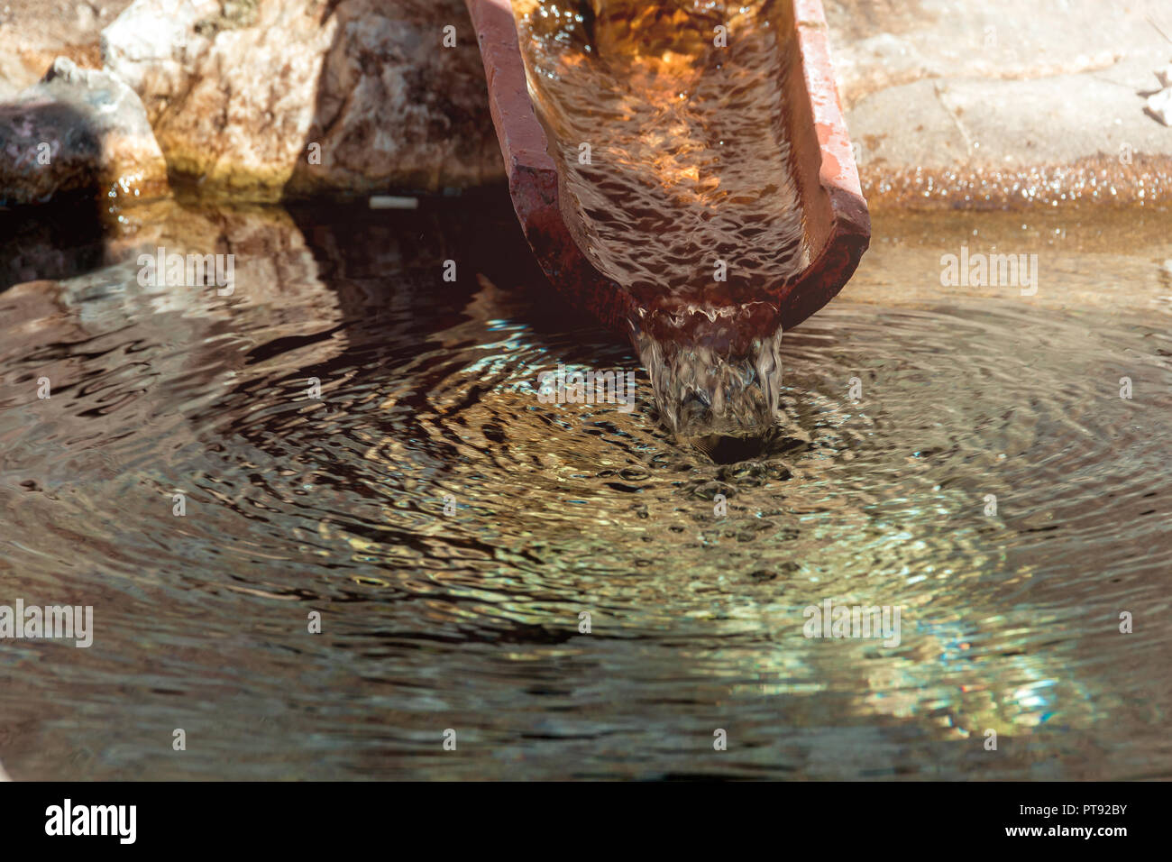 Water pouring from a drain pipe into a small stream Stock Photo - Alamy