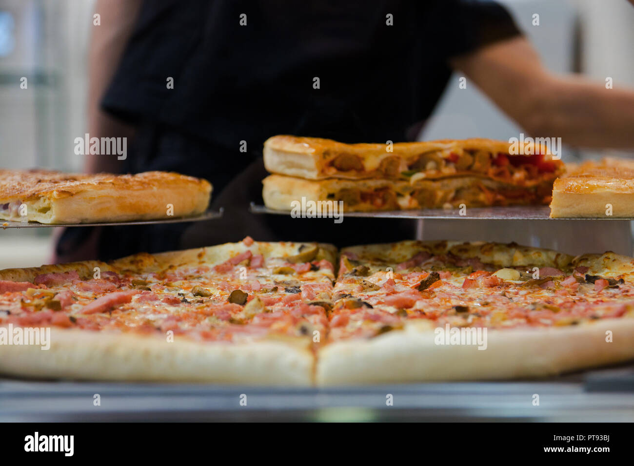 various pizza on a show-window in cafe with various ingredients Stock ...