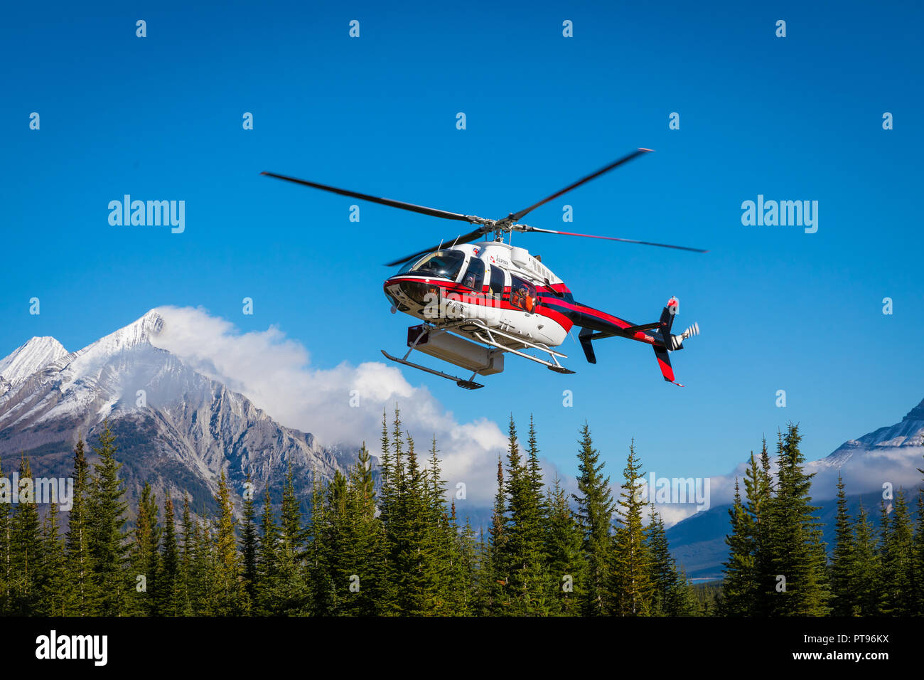 Helicopter taking off from Mount Shark helipad, near Canmore. Canmore ...