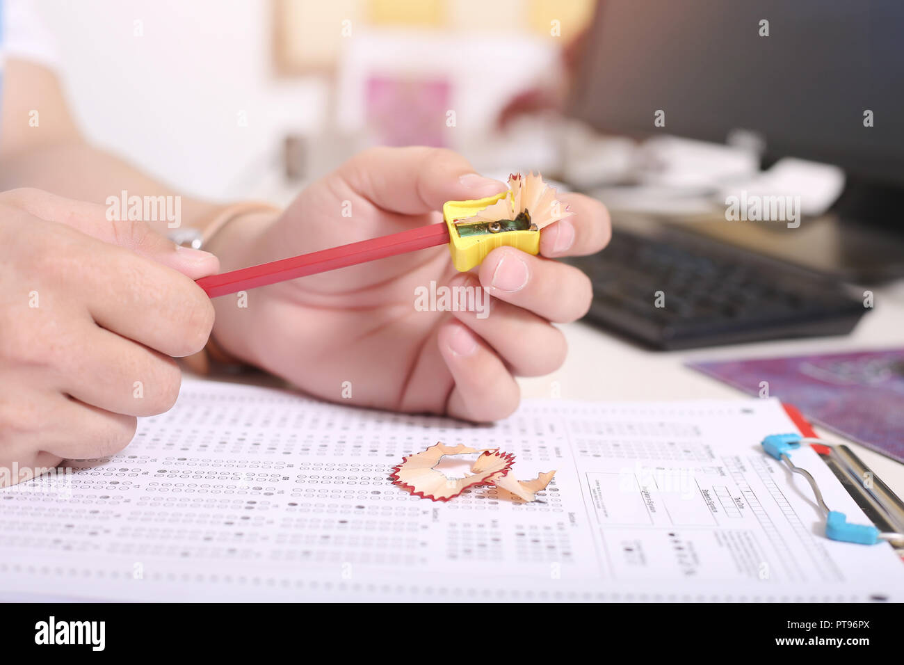 Man hand sharpening pencil with the help of sharpener. Picture of OMR ...