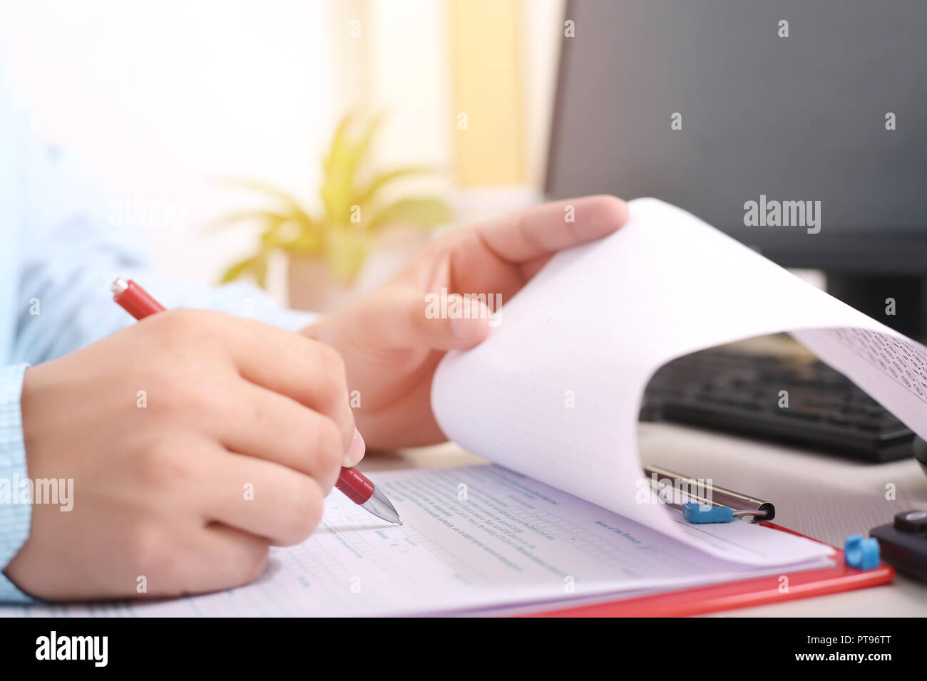 Man is filling form with pen. Picture of computer with form on the ...