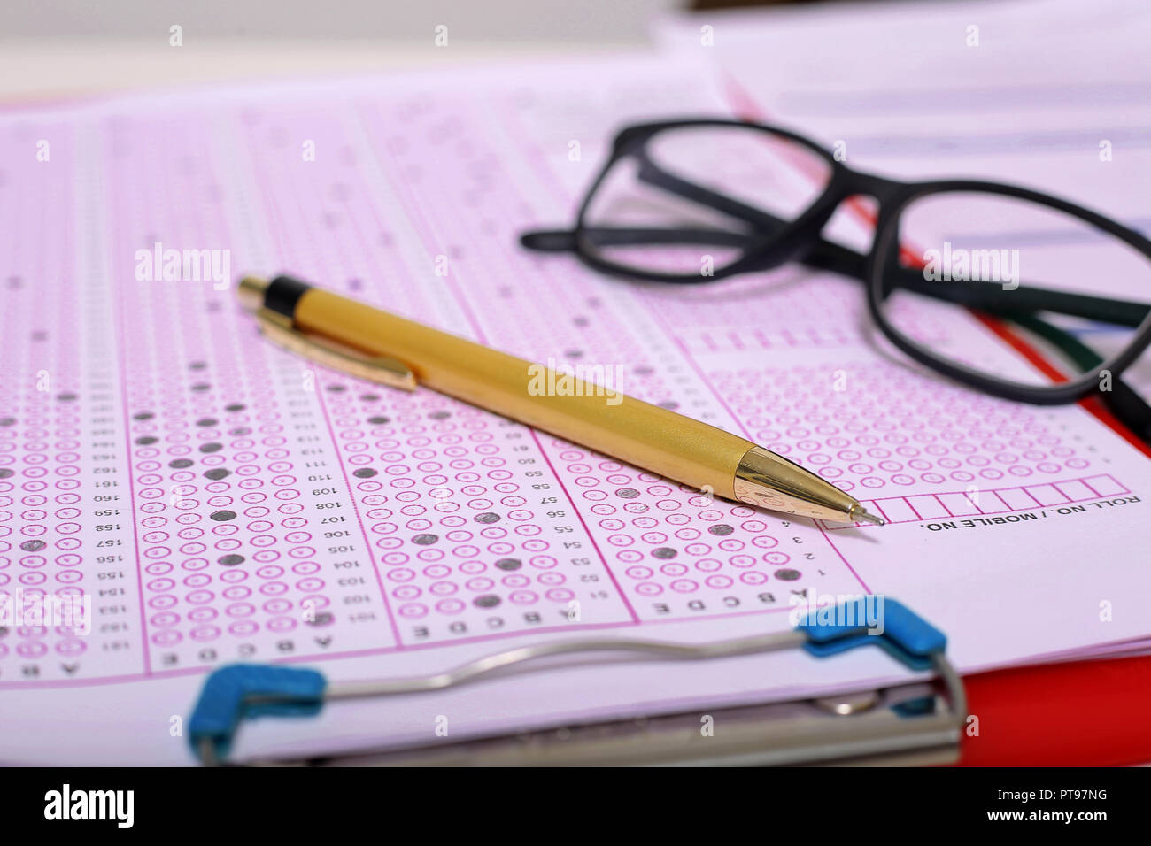 Picture of pen and glasses on the OMR sheet and OMR sheet on the ...