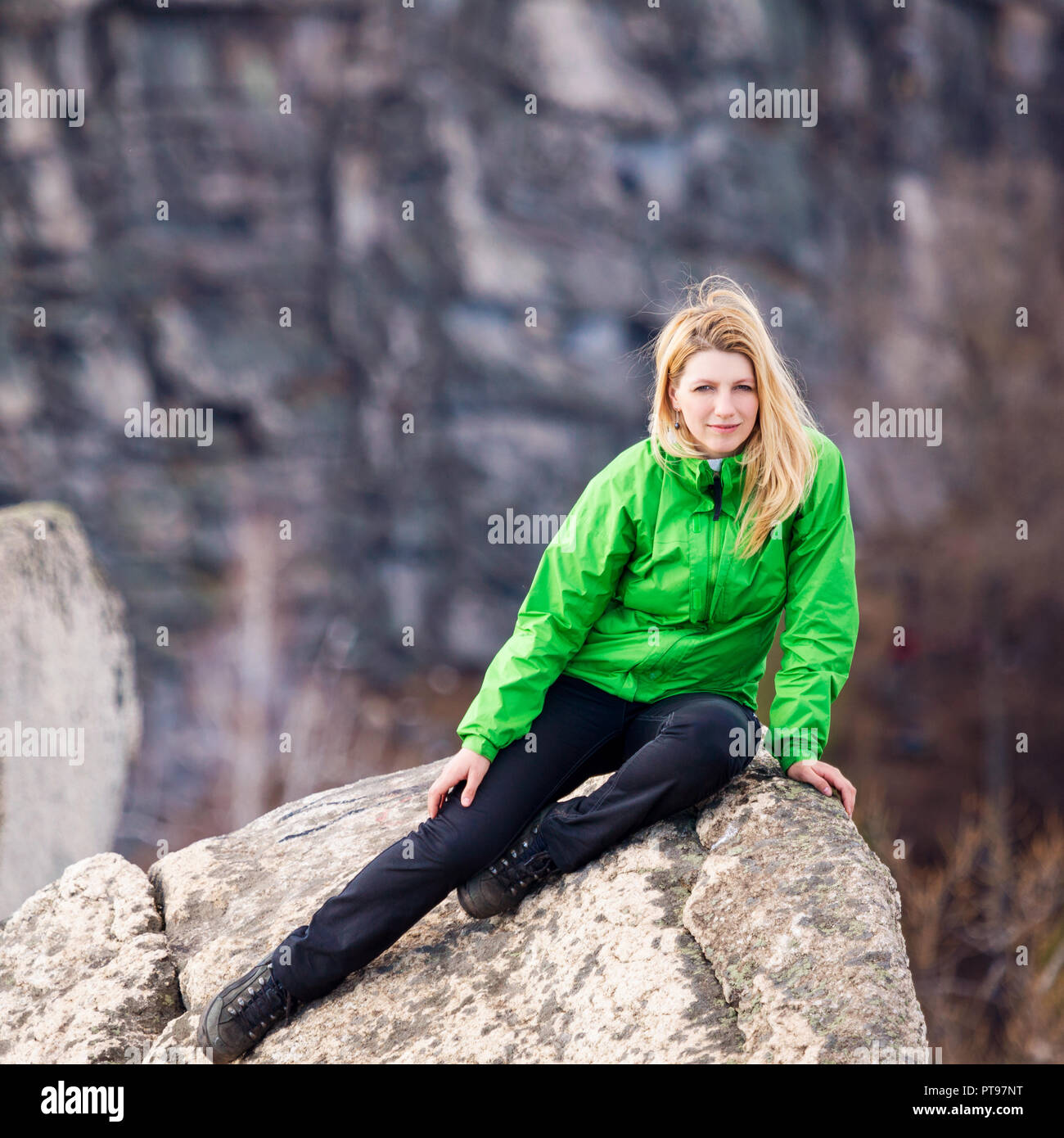 Beautiful woman sitting on rock hi-res stock photography and images - Alamy