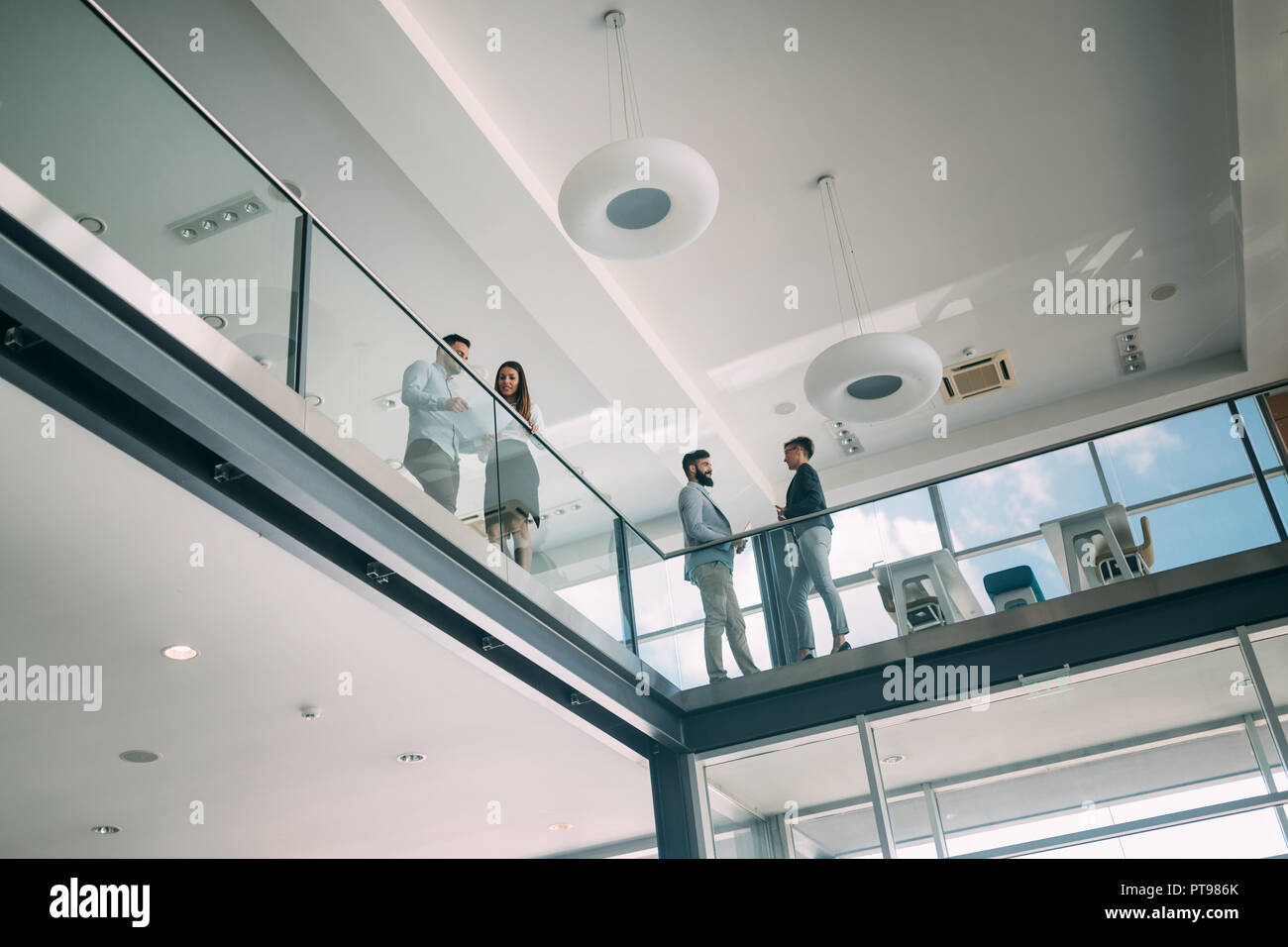 Picture of architects talking about project in hall Stock Photo - Alamy