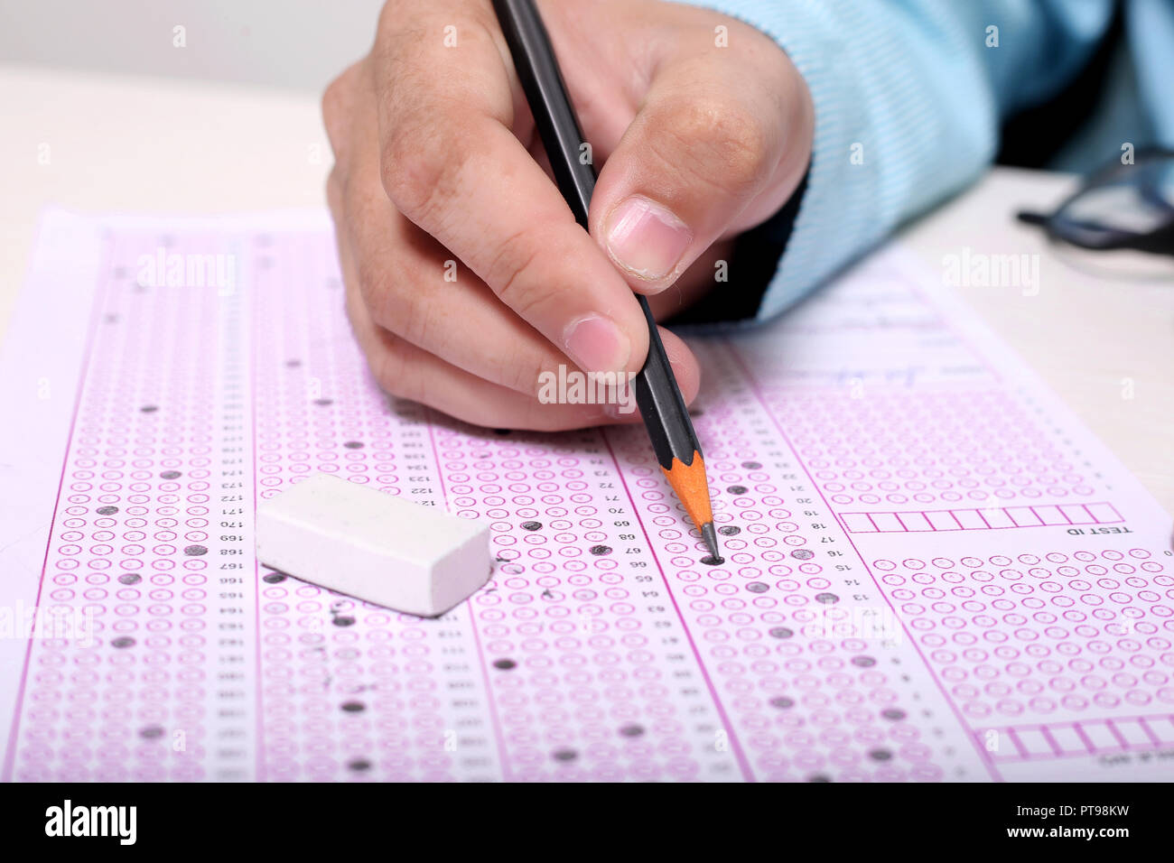 Man is filling OMR sheet with pencil. Photo of eraser on the OMR sheet ...