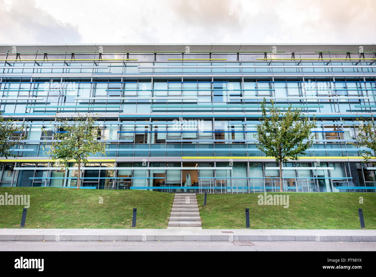 Exterior of large modern commercial office building with glass windows ...