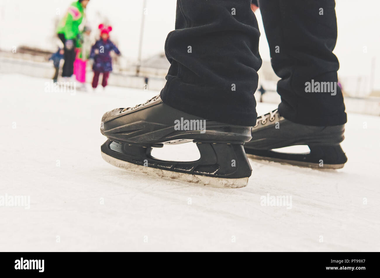 Men's feet in ice skating rink in black skates on the background of ...