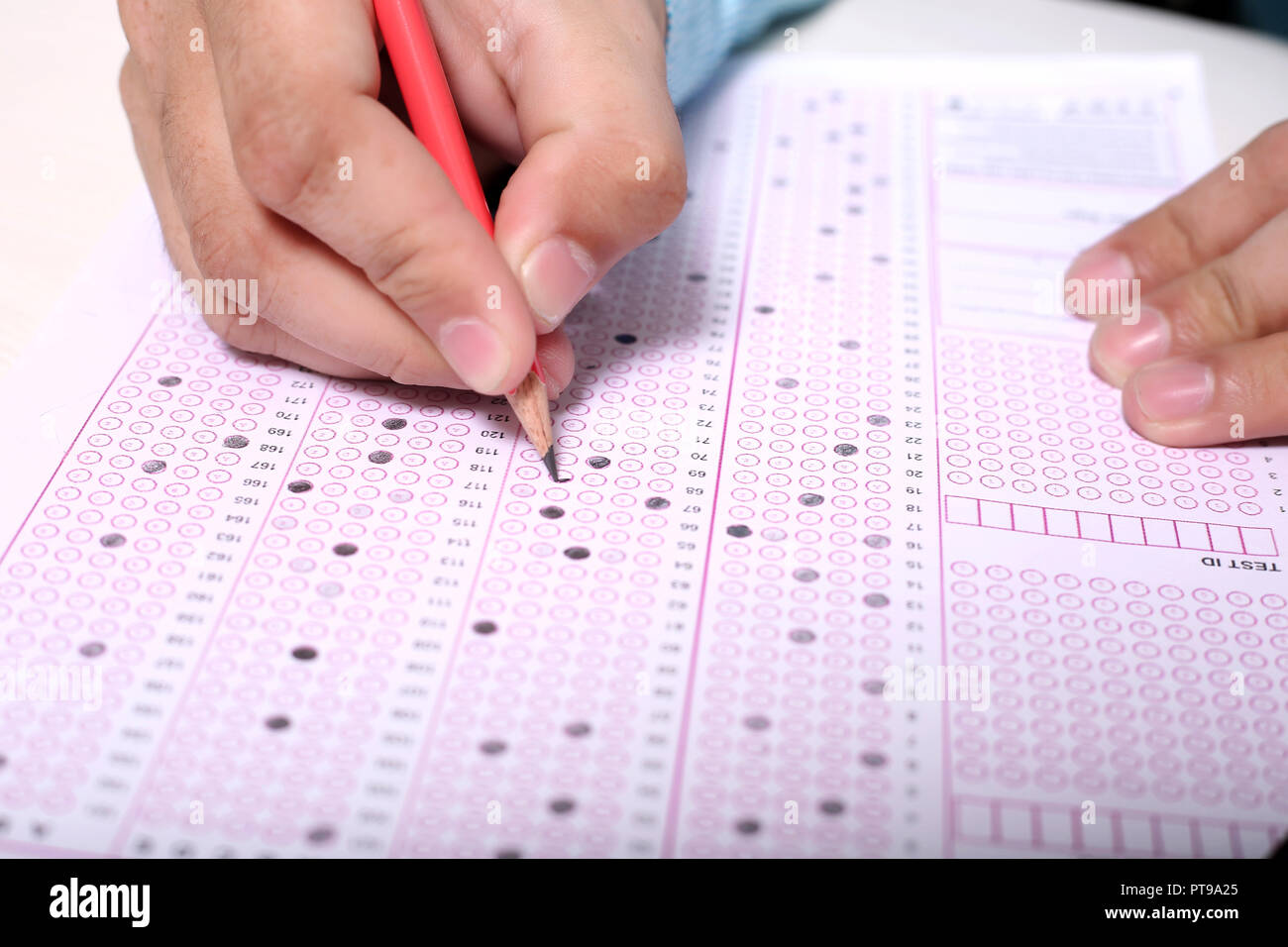 Picture of man is filling circle in OMR sheet with pencil Stock Photo ...