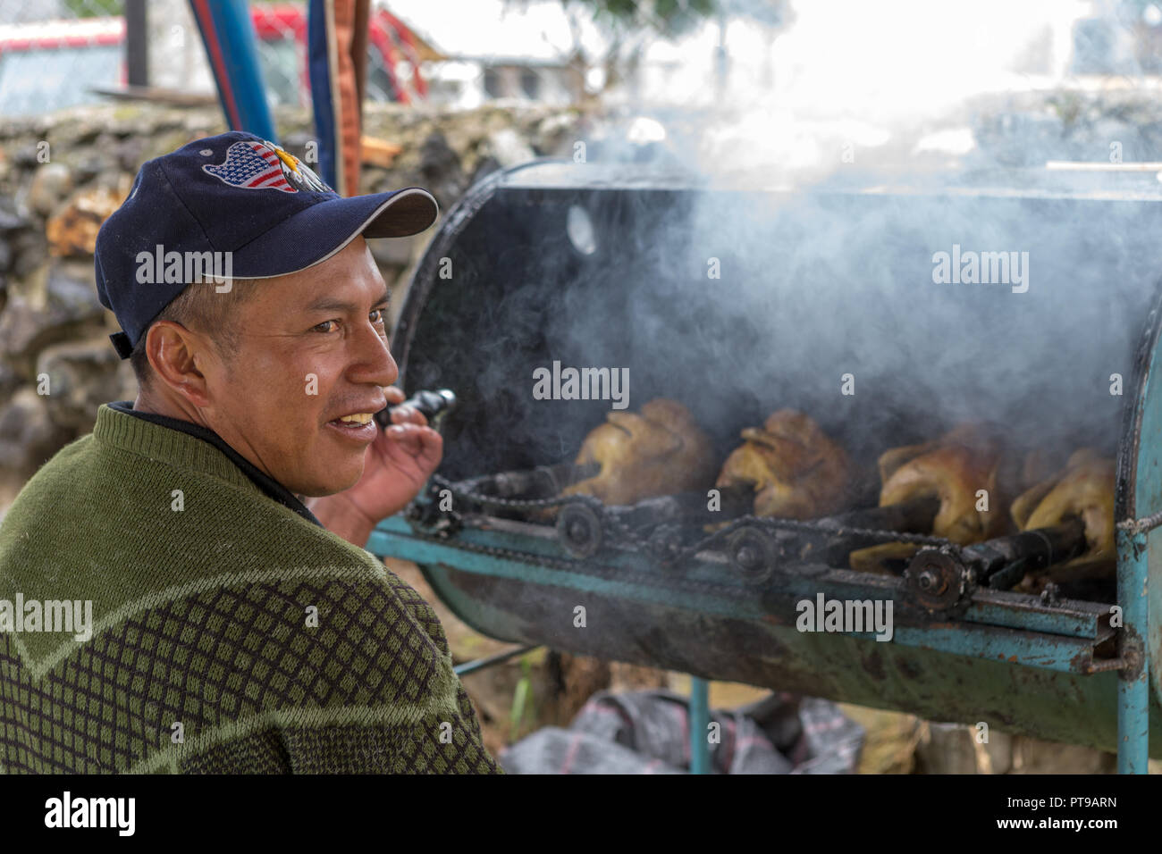 Outdoor market San Bartolome village nr Cuenca Ecuador - man roasting ...