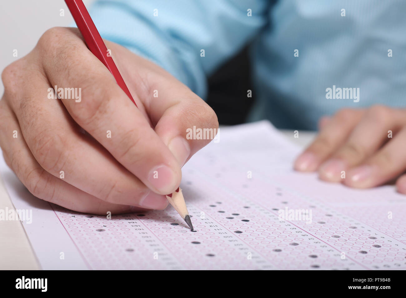 Picture of man is filling circle in OMR sheet with pencil Stock Photo ...