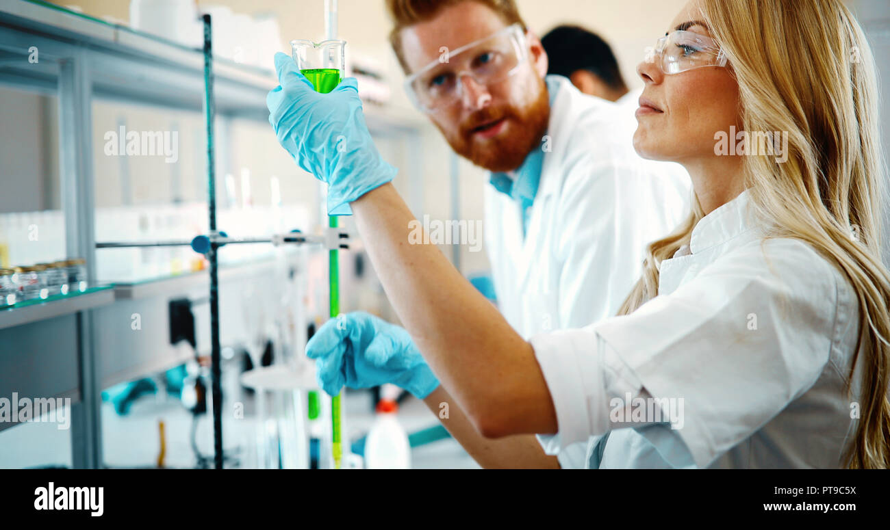 Group of chemistry students working in laboratory Stock Photo - Alamy