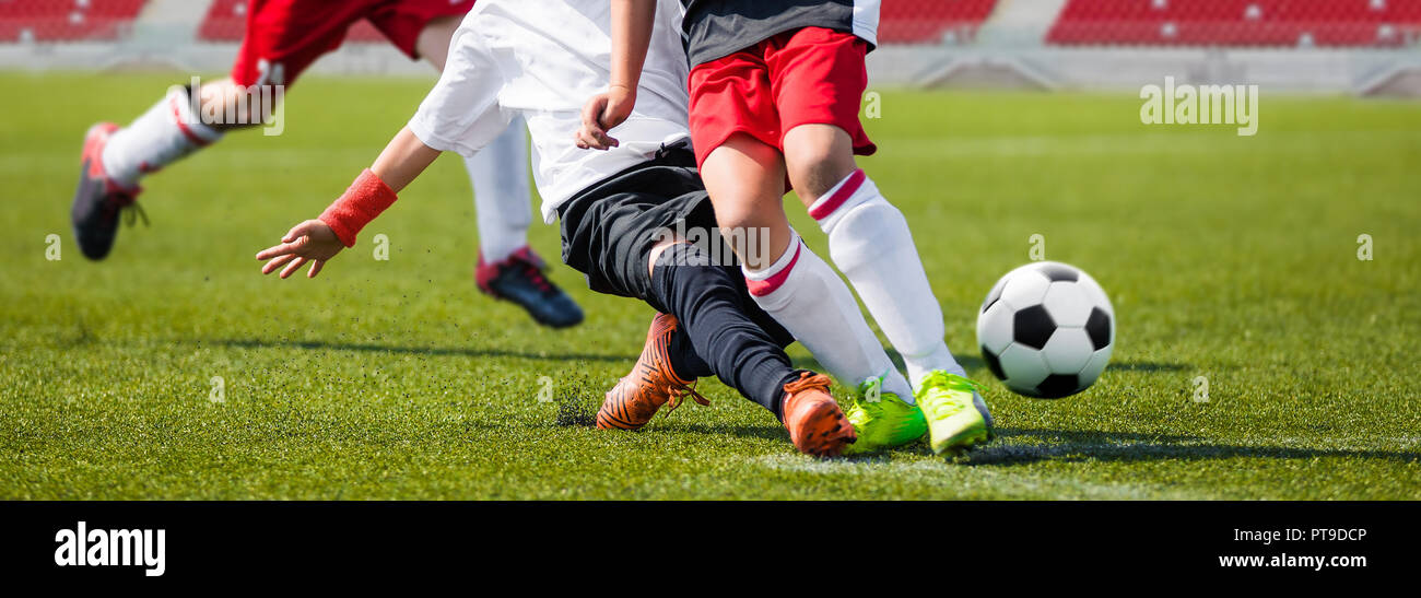 Football players in action kicking ball on stadium. Soccer players ...